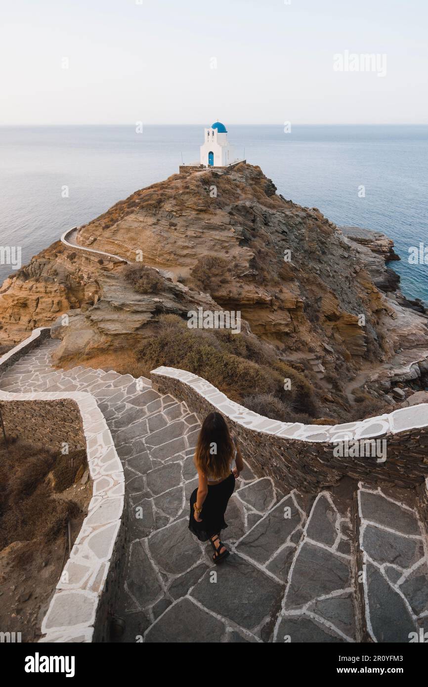 Girl walking down some stairs on her way to a pretty church on top of a ...