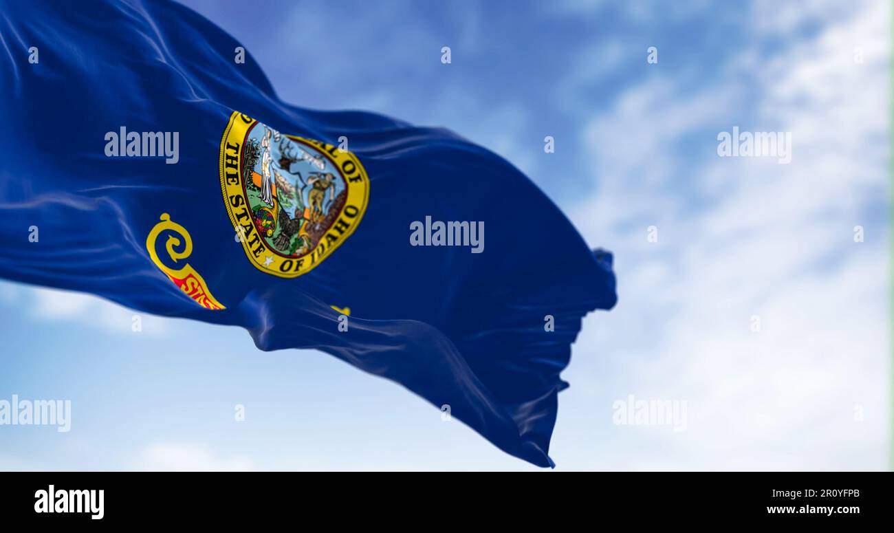 Idaho state flag fluttering in the wind. Blue background with the state ...