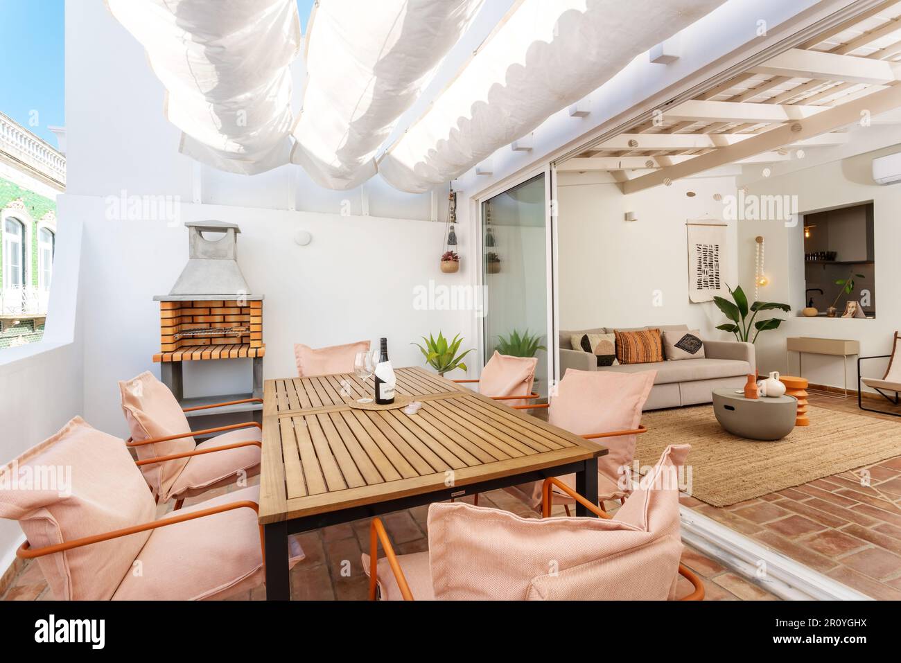 Balcony terrace with barbecue picnic overlooking the living room inside ...