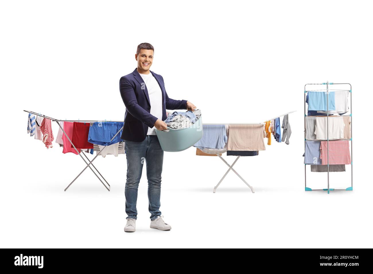 Full length portrait of a young man holding a laundry basket in front ...