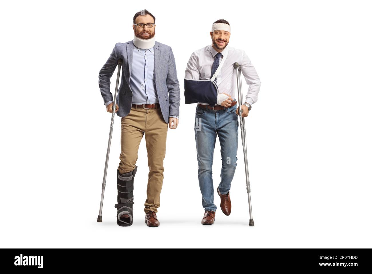 Two young injured men standing with crutches isolated on white ...