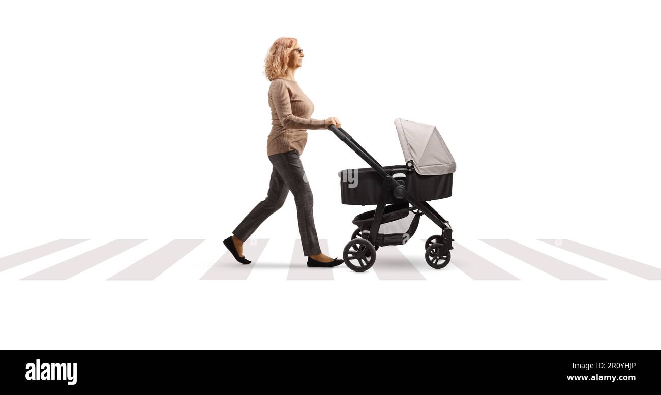 Full length profile shot of a mature woman pushing a baby stroller at a ...