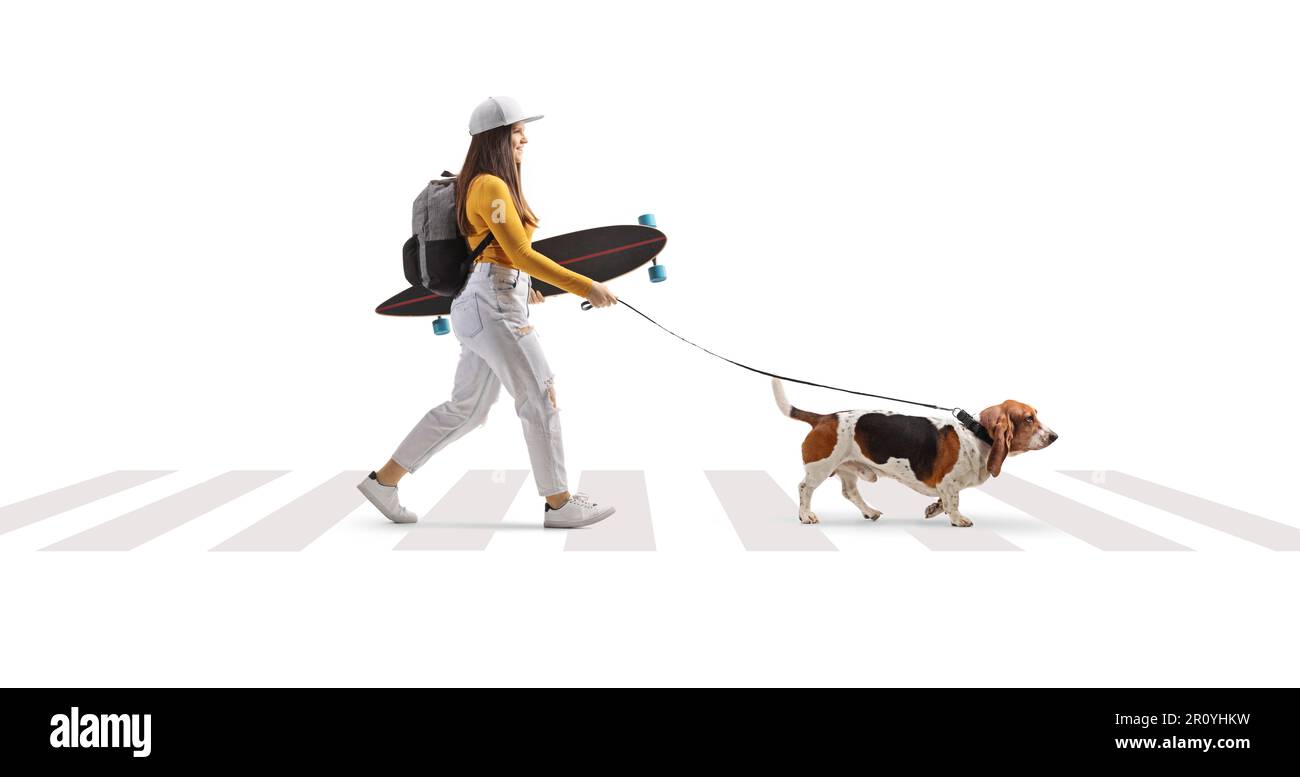 Full length profile shot of a young female with a longboard and a ...