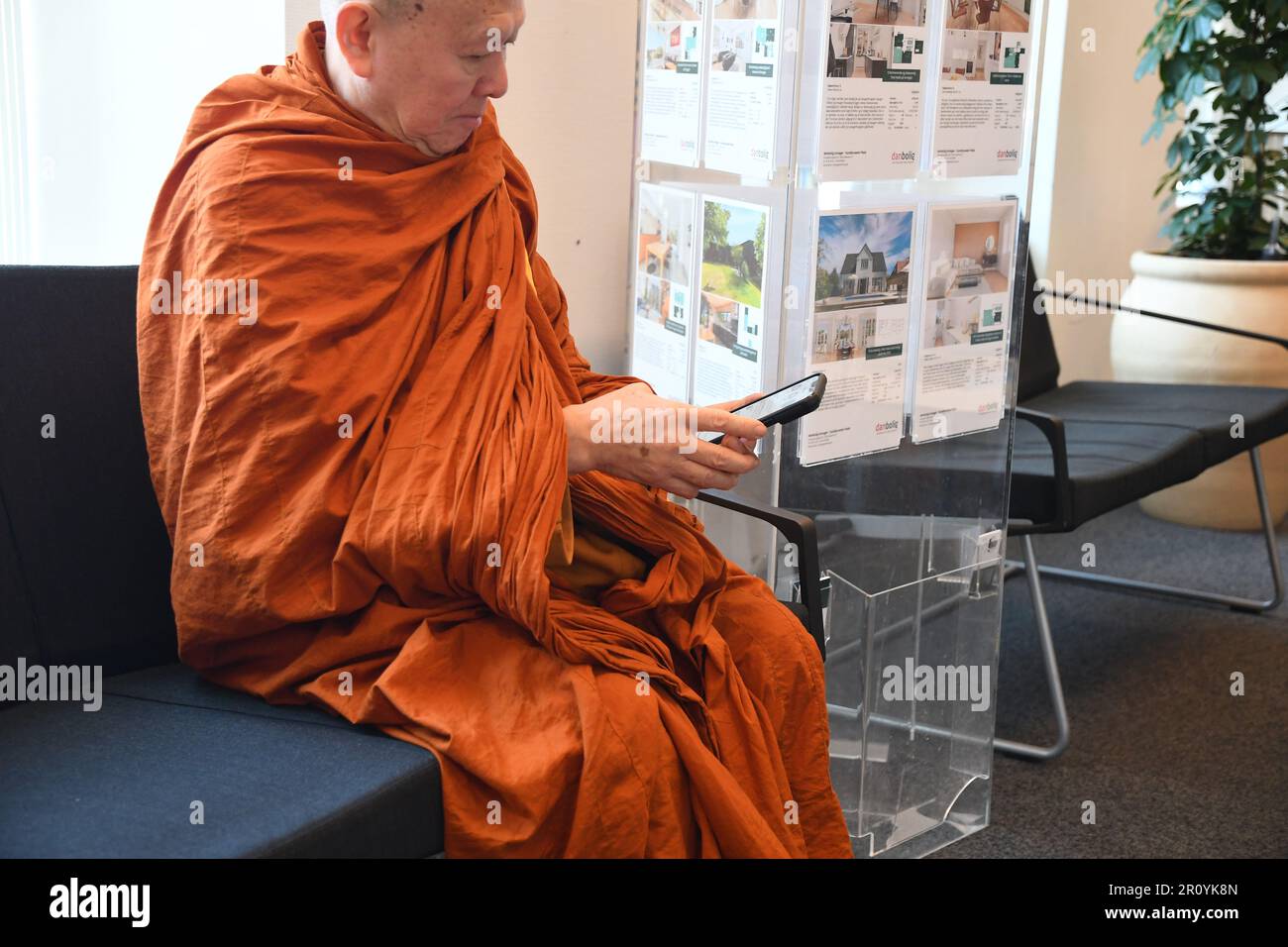 Copenhagen /Denmark/10 May 2023/Monk with modern cellphone in danish ...