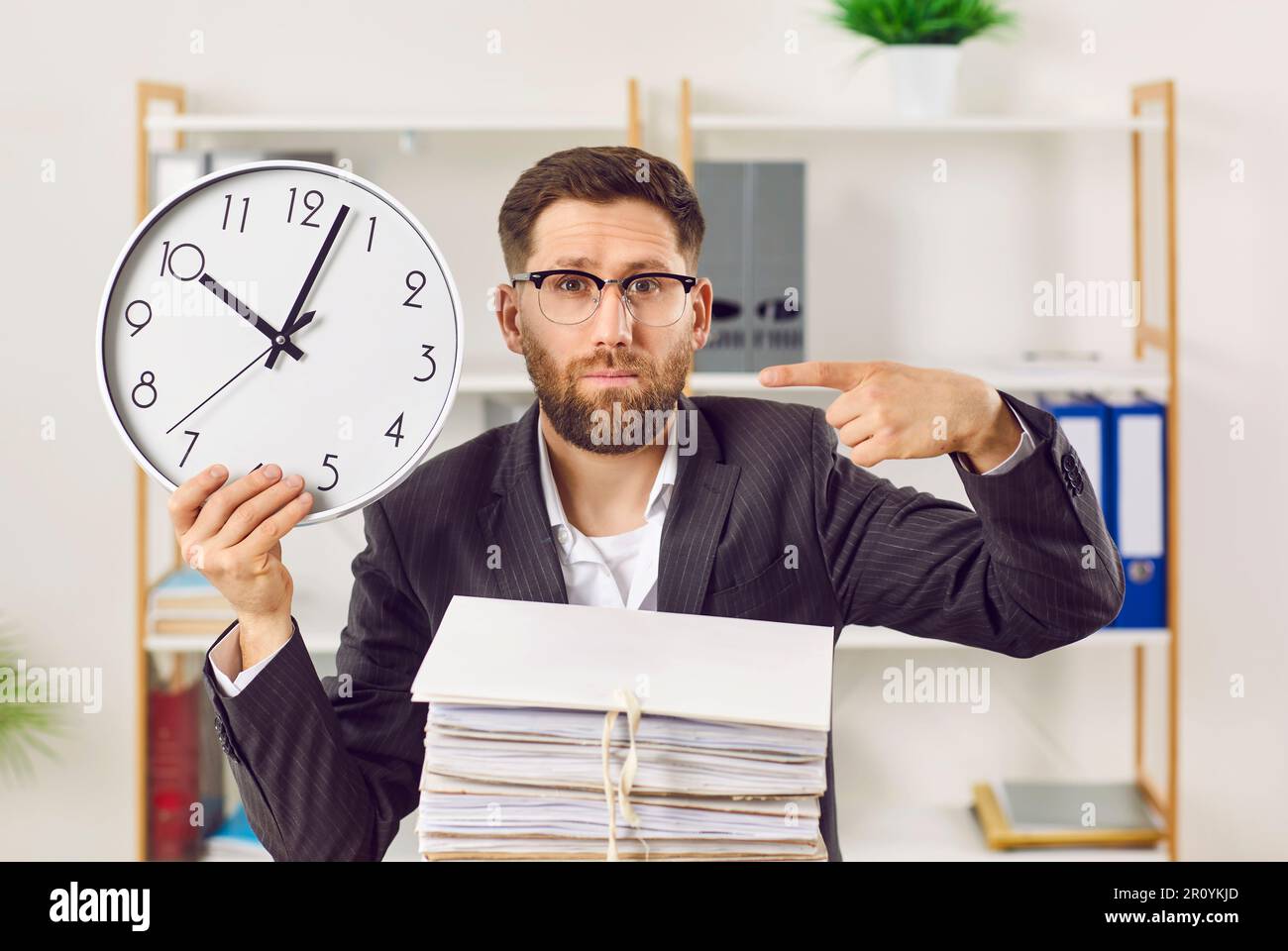 Portrait exhausted workaholic manager checking hi-res stock photography ...