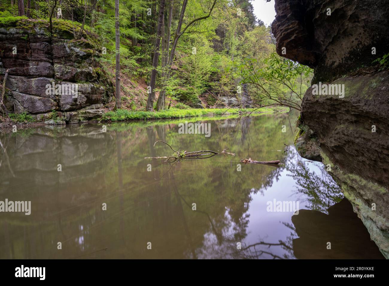 A picturesque waterfall cascading down a rocky cliff face surrounded by ...