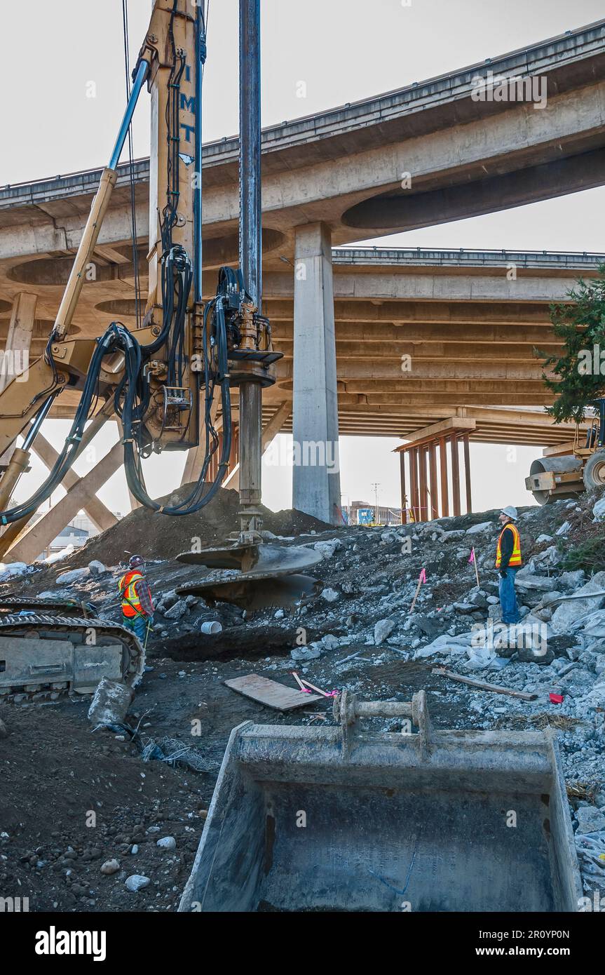 Workers and a drilling rig for digging drilled shafts to support ...