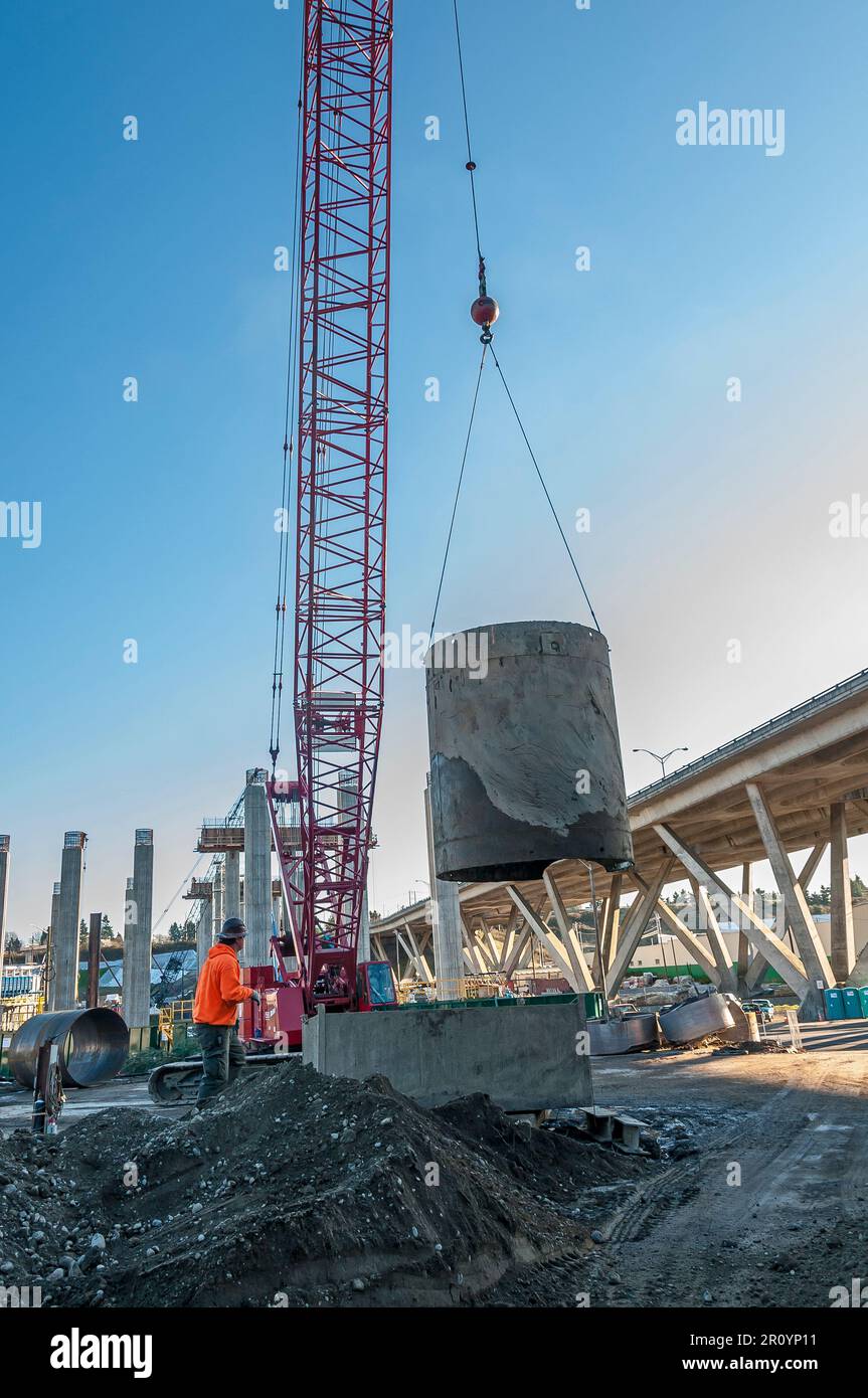 Workers and a pipe casing (caisson) for drilled shaft to support ...