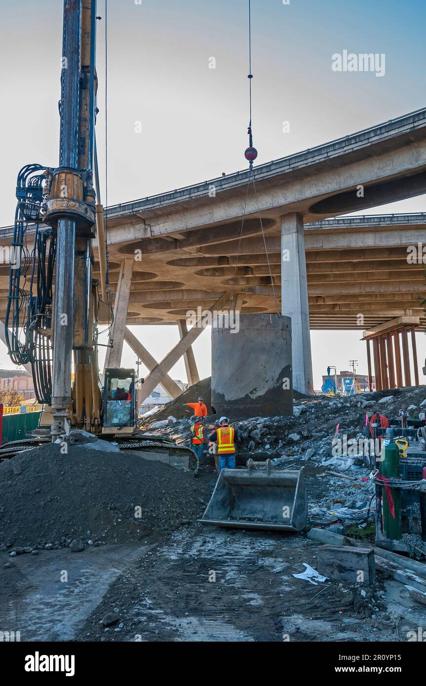 Workers and a drilling rig for digging drilled shafts to support ...