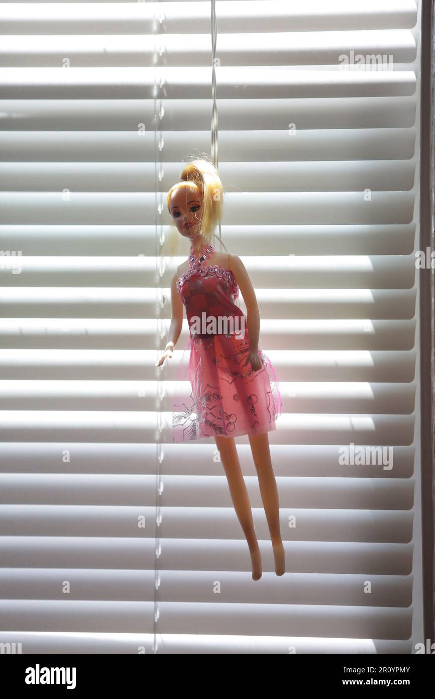A barbie doll dangles from a cord which decorates Kathy Gray's room at ...