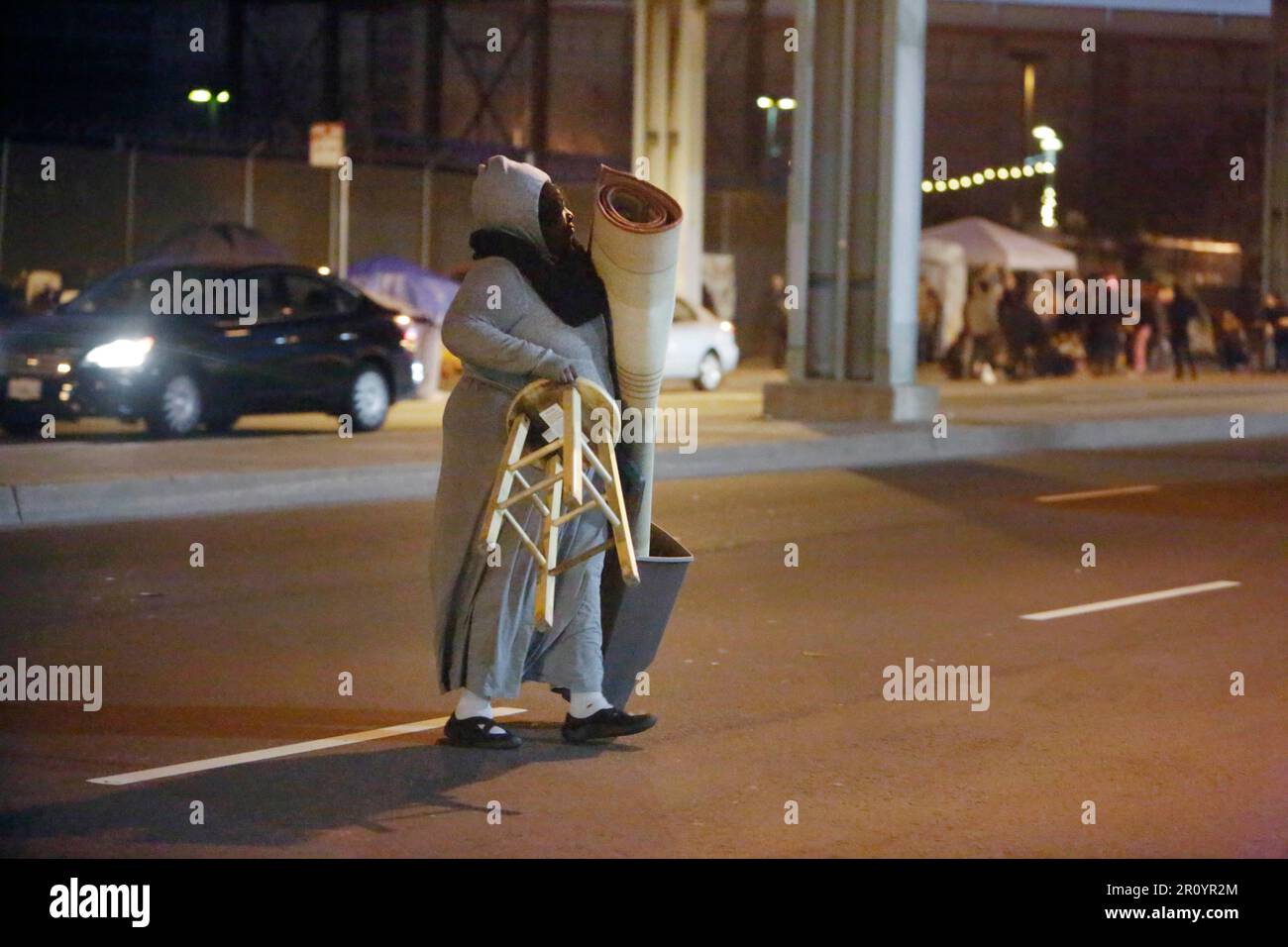 Angela Flax, homeless resident, moves belongings across 13th Street as ...
