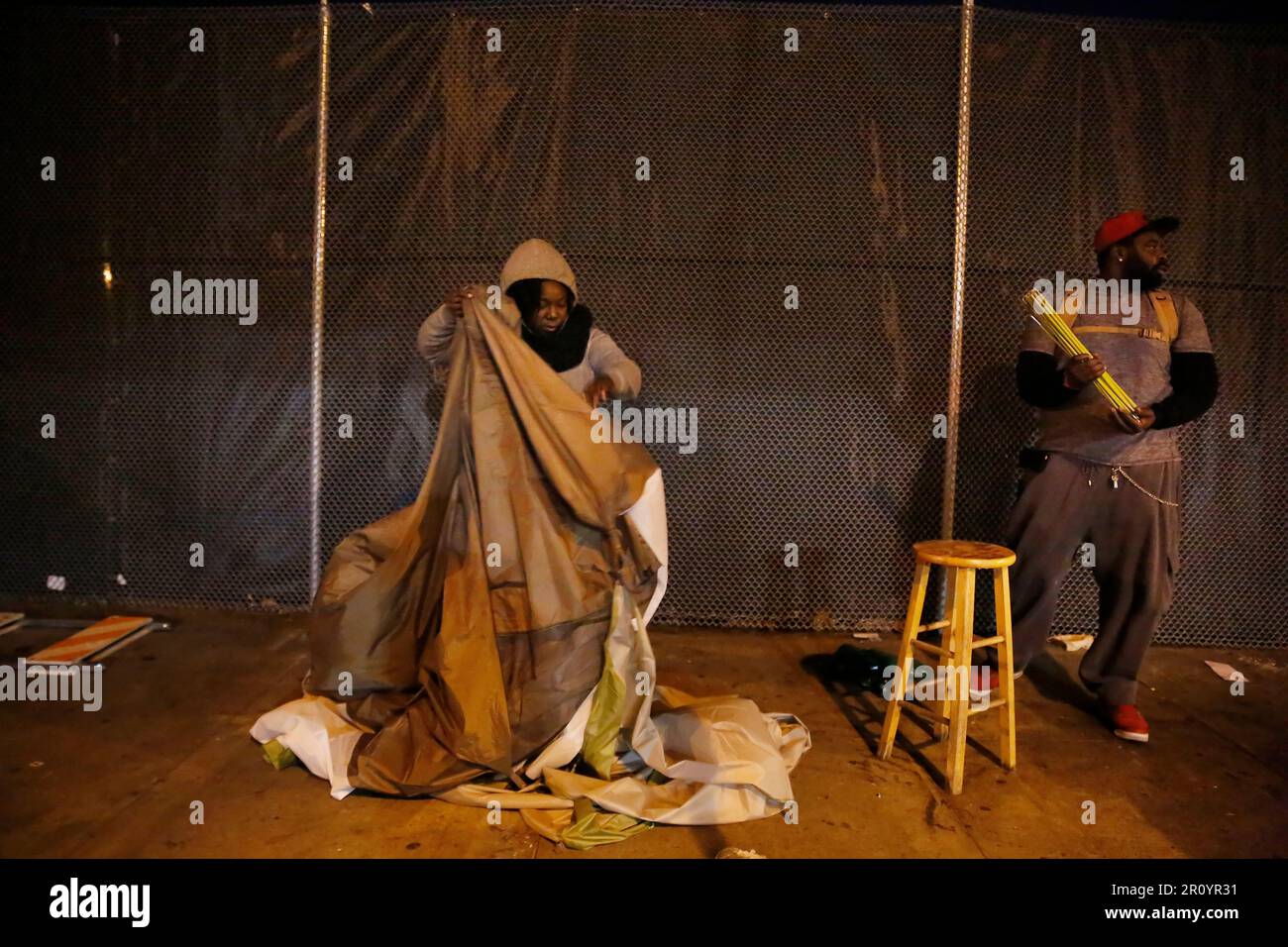 Angela Flax, homeless resident, packs up her tent and other belongings ...