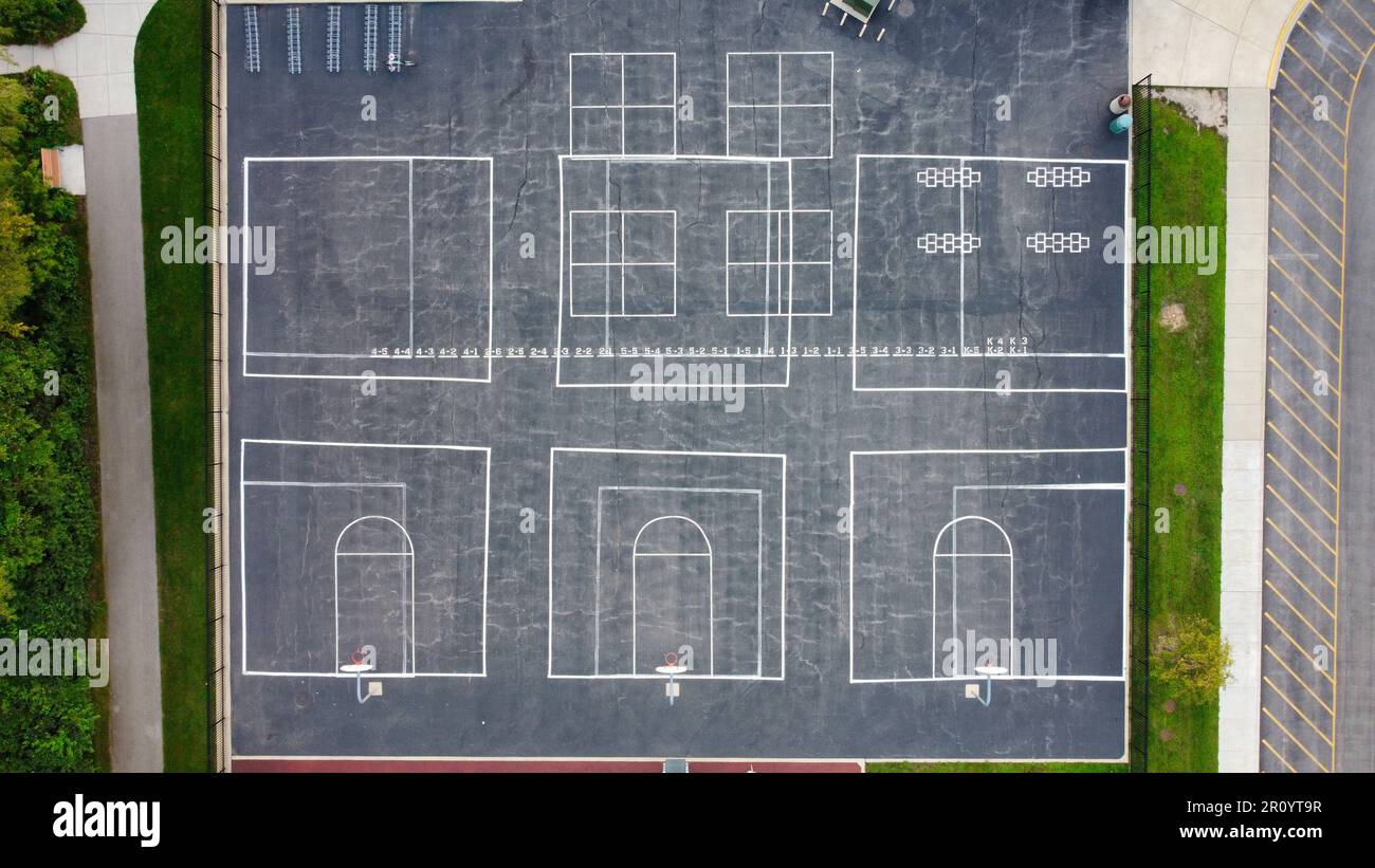 A car is driving on a road in the foreground of an aerial view of a ...