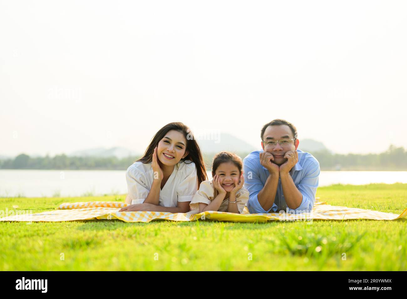 Happy family relaxing and resting in park together on weekend Stock ...