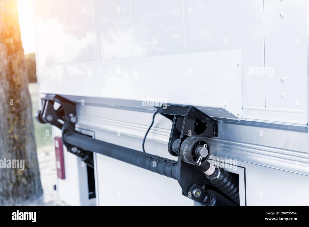 Close-up detail view of modern white delivery truck tail door with ...