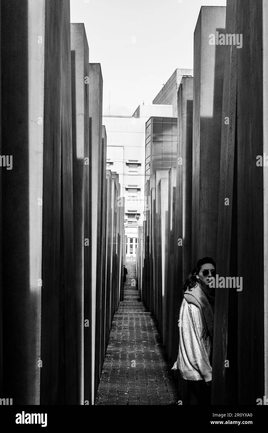 Women standing next to monolith Stock Photo - Alamy