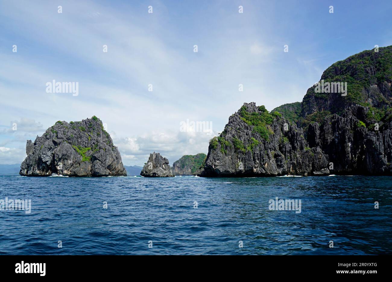 massive limestone rocks in the blue sea at the el nido archipelago ...