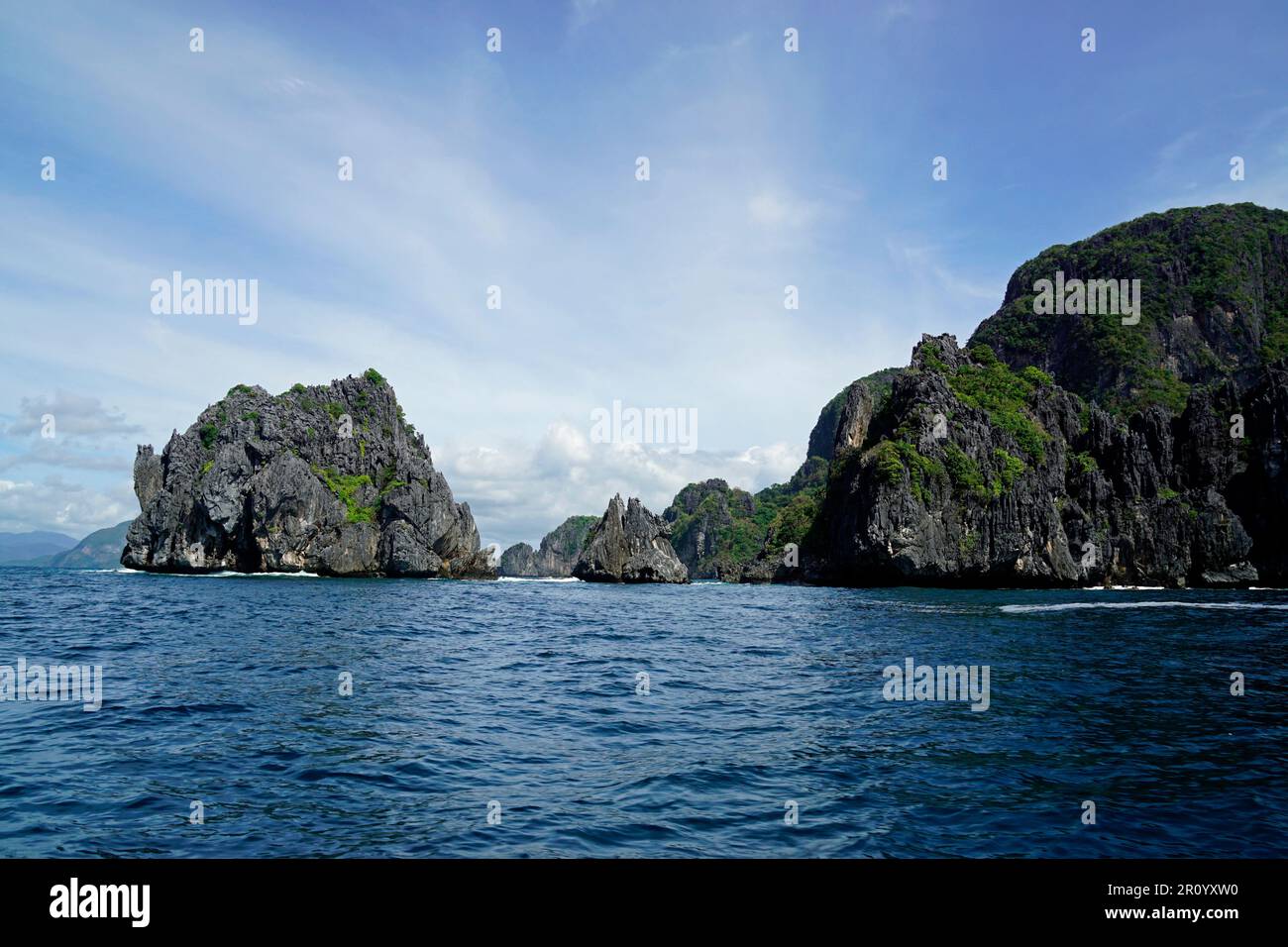 massive limestone rocks in the blue sea at the el nido archipelago ...