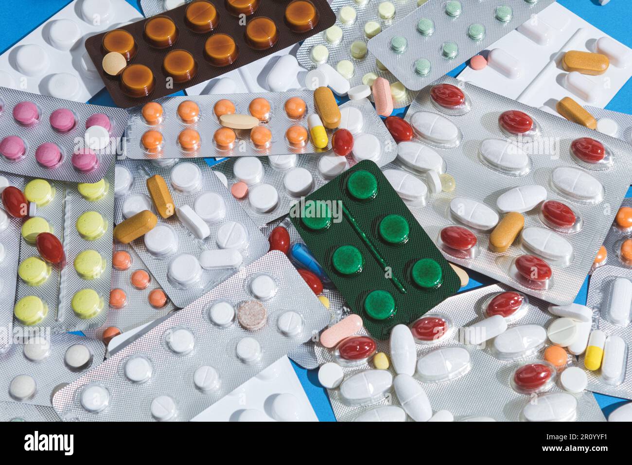 A large pile of pills in bundles scattered on the table. A mound of ...