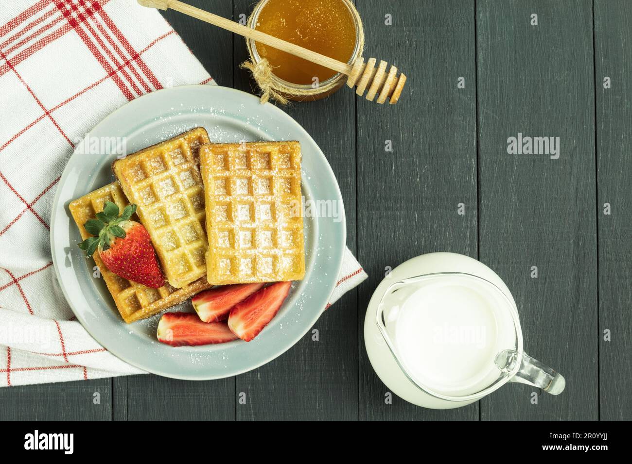 Belgian waffles and fresh fruit on a plate. Gray waffles on a rustic ...