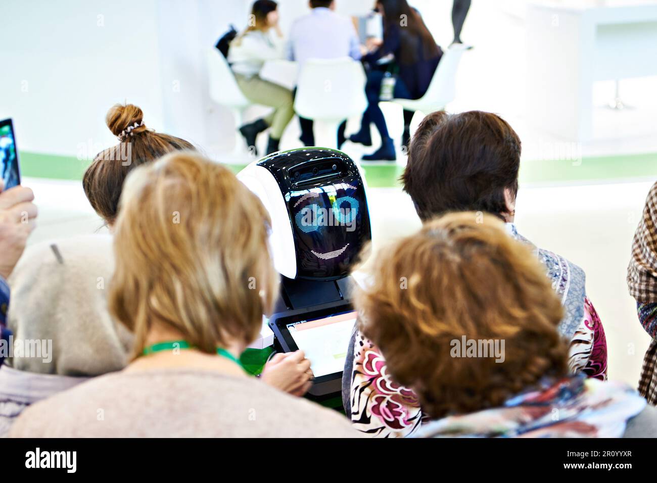Robot information assistant among people at the exhibition Stock Photo ...