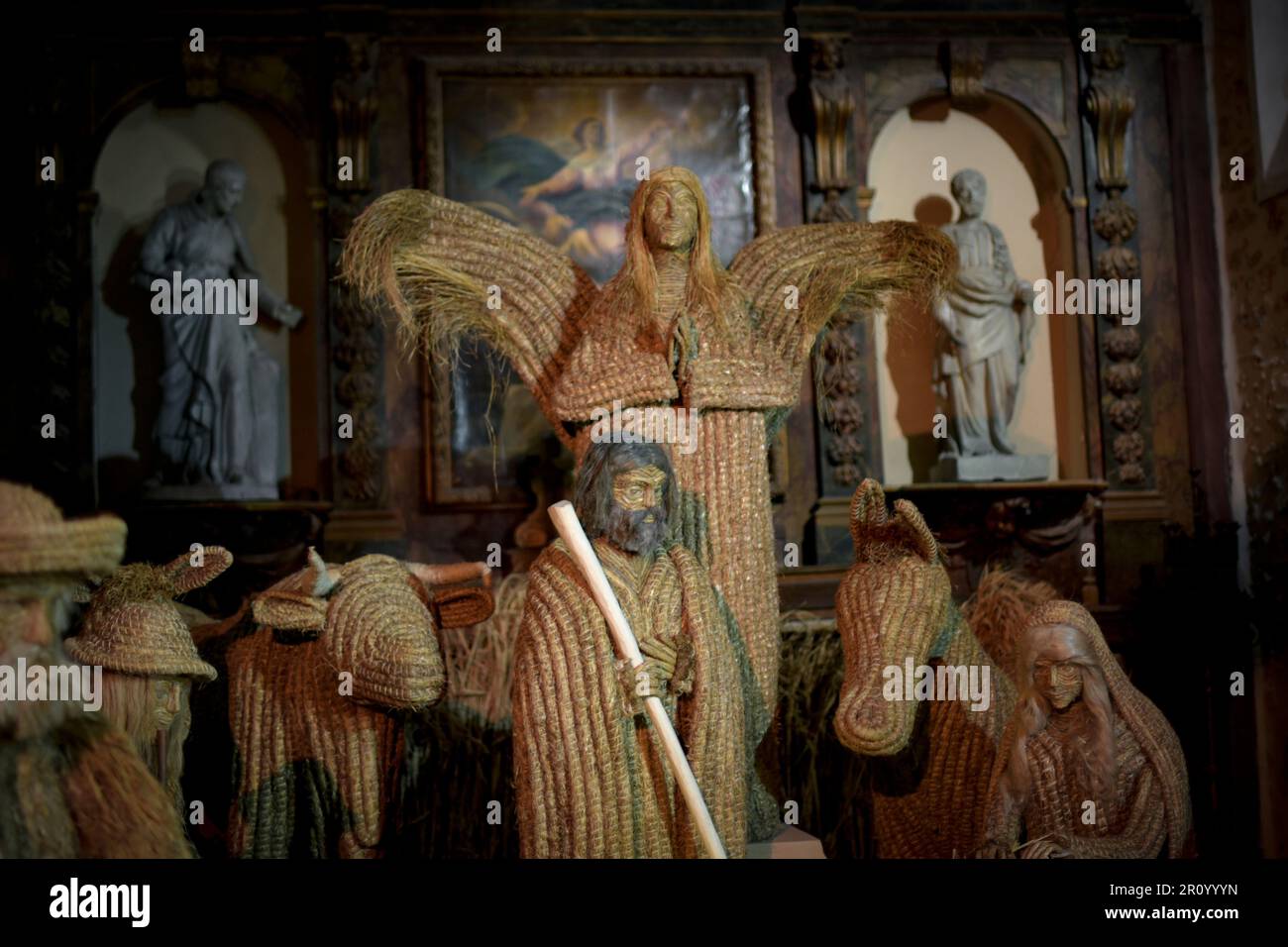 view of a beautiful straw nativity scene inside a church at Christmas ...
