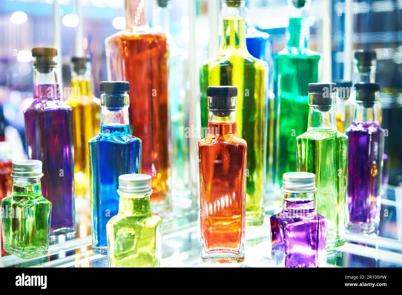 Glass bottles with colored liquids in a store Stock Photo - Alamy