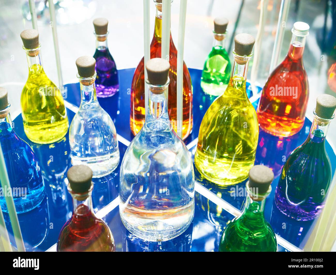 Glass bottles with colored liquids in a store Stock Photo - Alamy