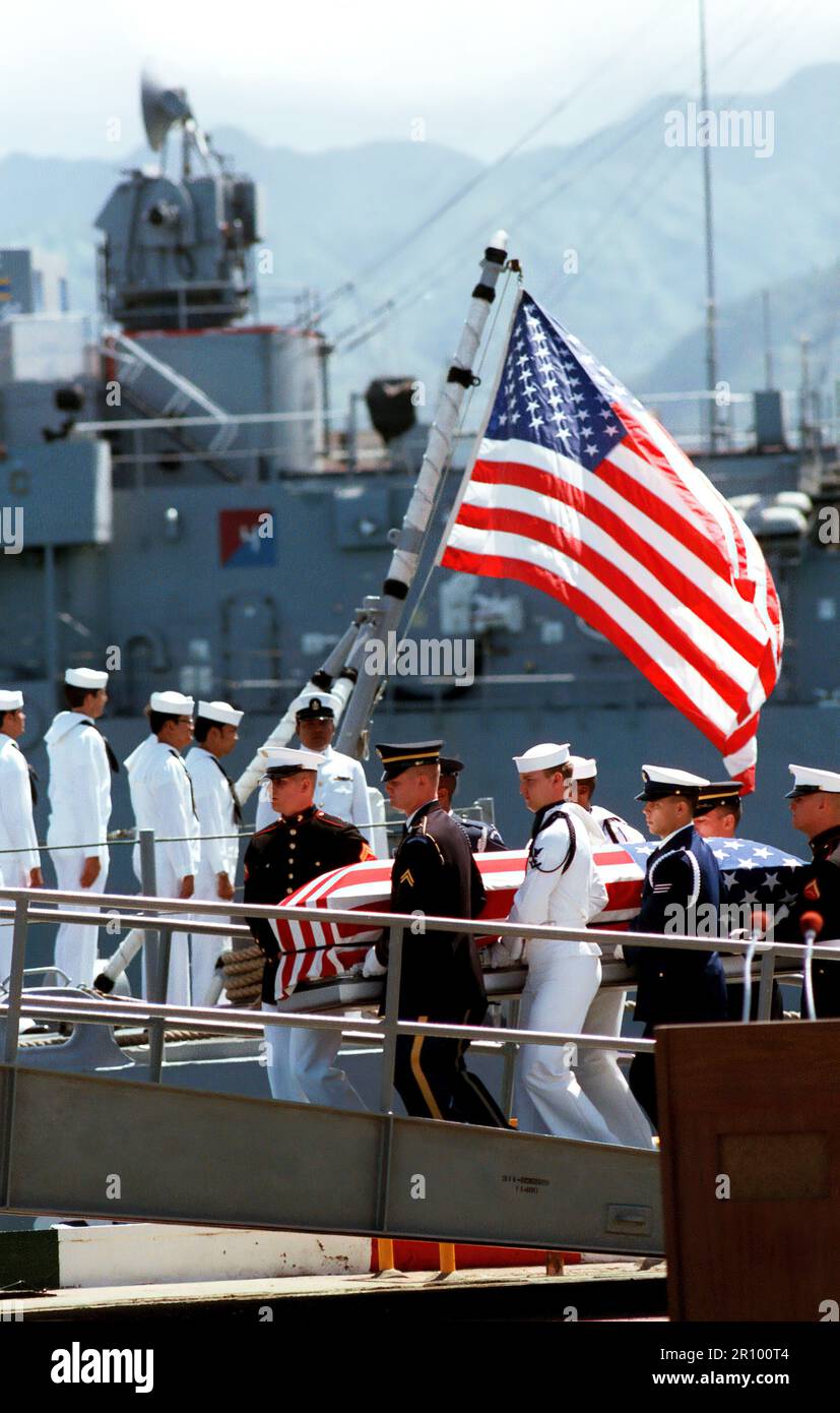 A joint services casket team carries the flag-draped casket of the ...