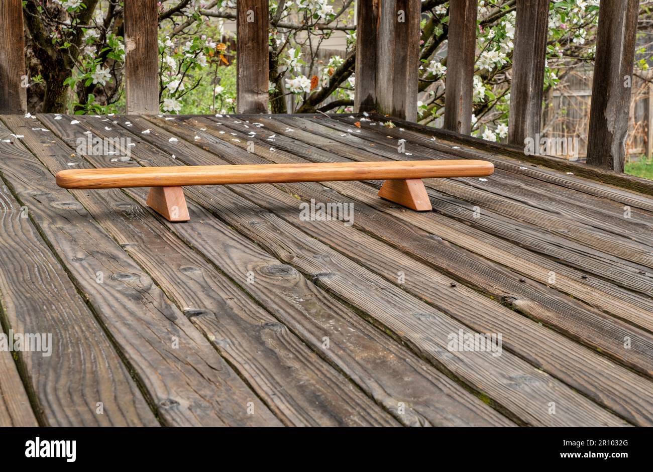 Persian shena push up board on a backyard wooden deck in springtime ...