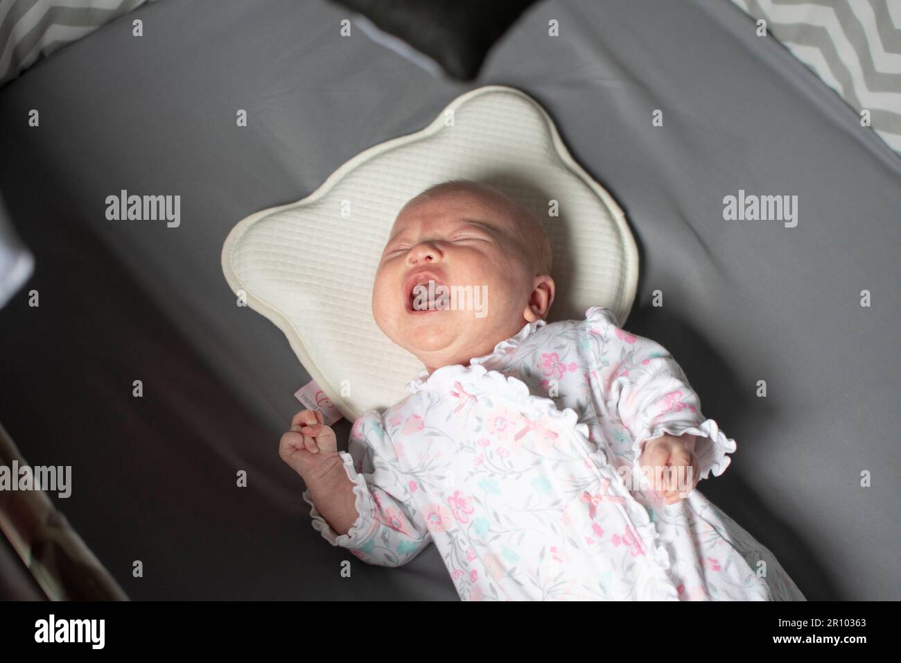 Crying newborn baby in a crib Stock Photo - Alamy