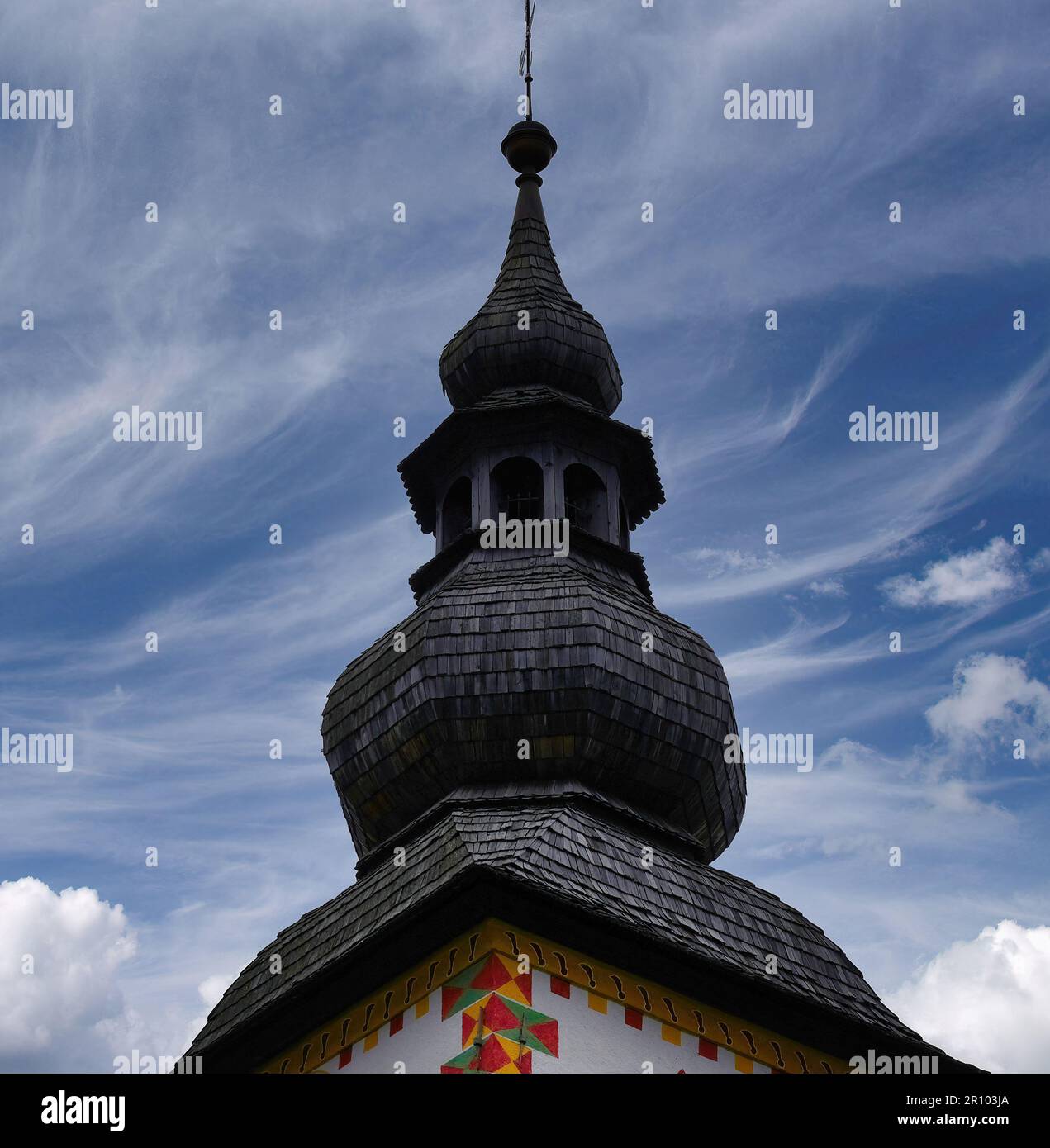 An old church with a pointed tall tower and a wooden roof at Lake ...