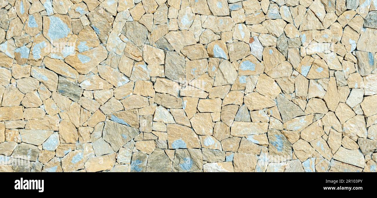 Masonry wall of natural brown stones with irregular pattern texture ...