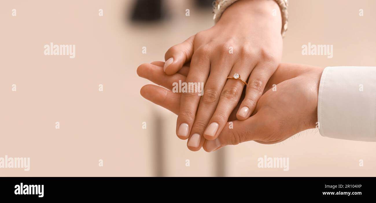 Engaged couple holding hands, closeup Stock Photo - Alamy