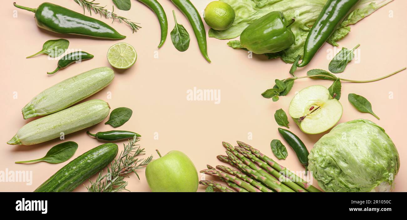 Frame made of different fresh vegetables and fruits on beige background ...