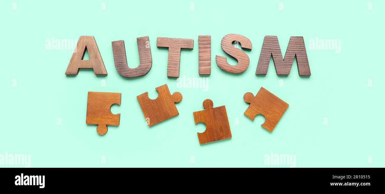 Word AUTISM with jigsaw puzzle pieces on turquoise background Stock ...