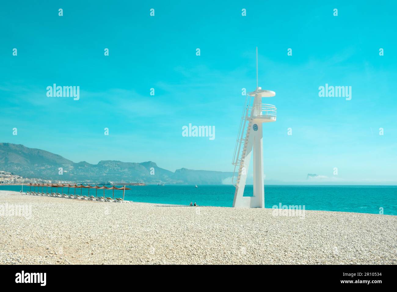 View to beautiful Albir seaside beach with white lifeguard tower and ...