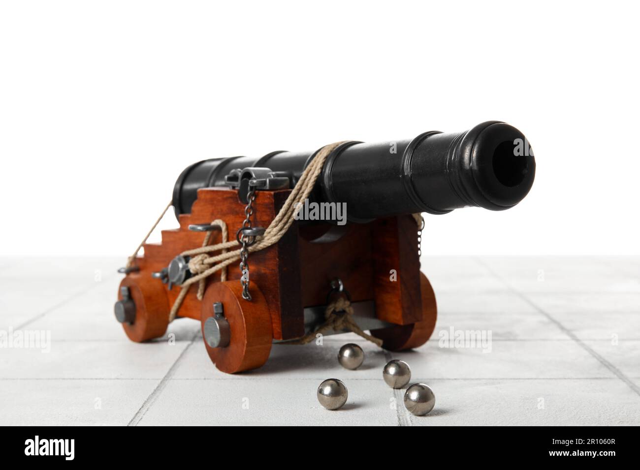 Toy model of cannon on table against white background Stock Photo - Alamy