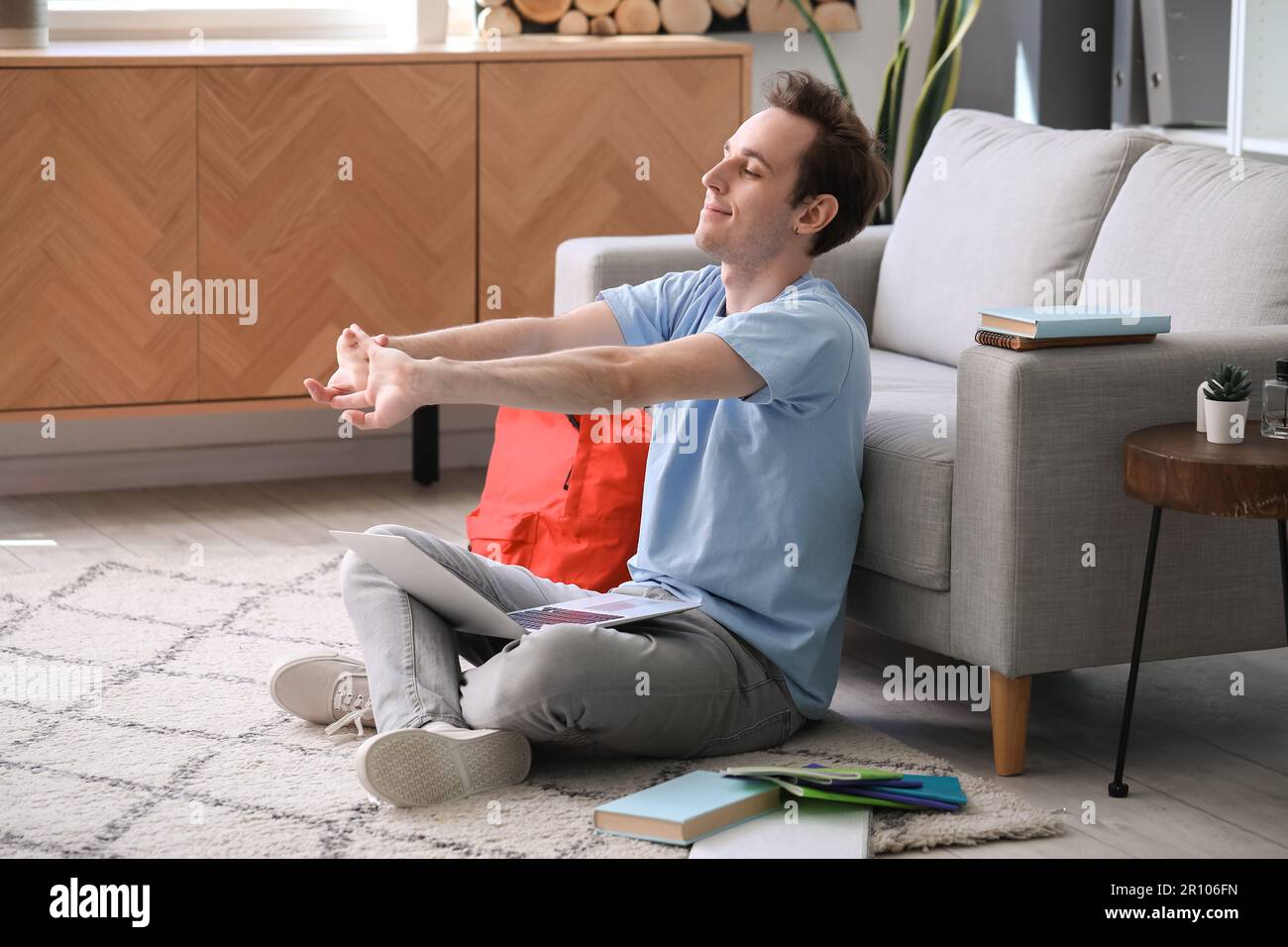 Male student resting after doing lessons at home Stock Photo - Alamy