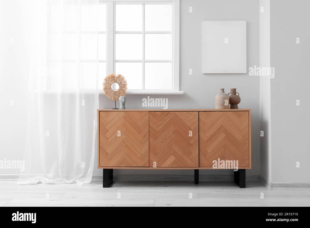 Stylish wooden cabinet near window Stock Photo - Alamy