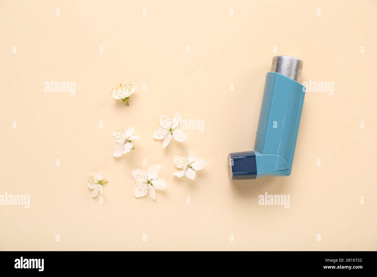 Asthma inhaler with flowers on beige background Stock Photo - Alamy