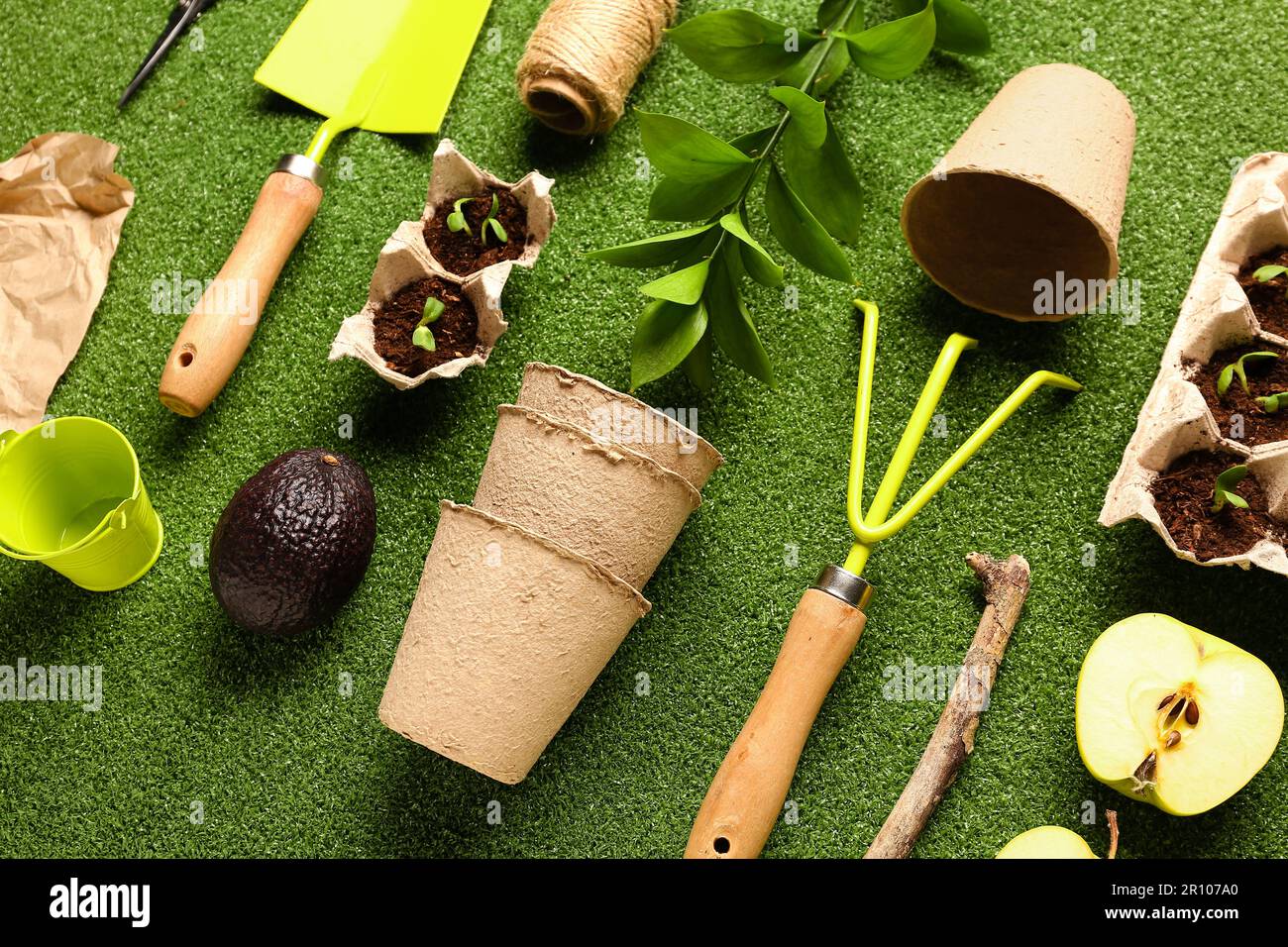 Cardboard boxes with seedlings, peat pots, fruits, and gardening tools ...