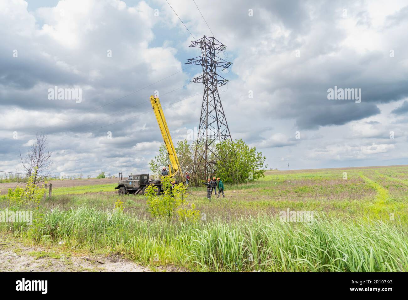 Workers fixing electric power transmission line destroyed during ...