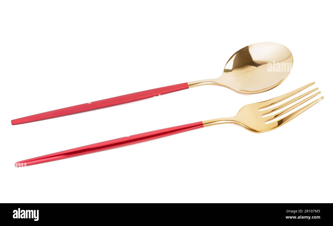 Golden spoon and fork with red handles on white background Stock Photo ...