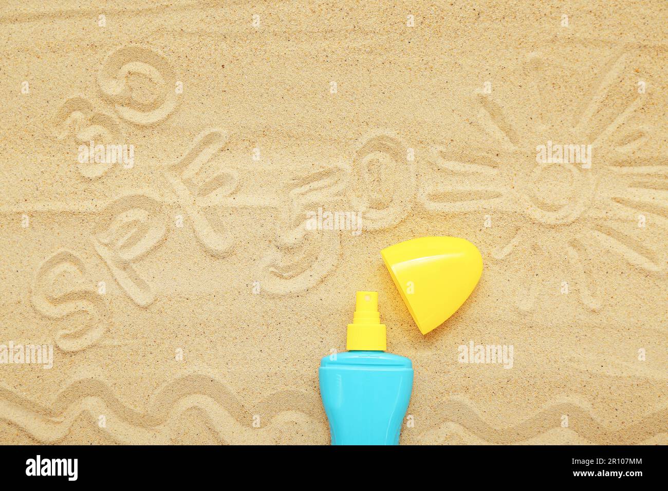 Creative composition with sunscreen cream and drawings on sand Stock ...
