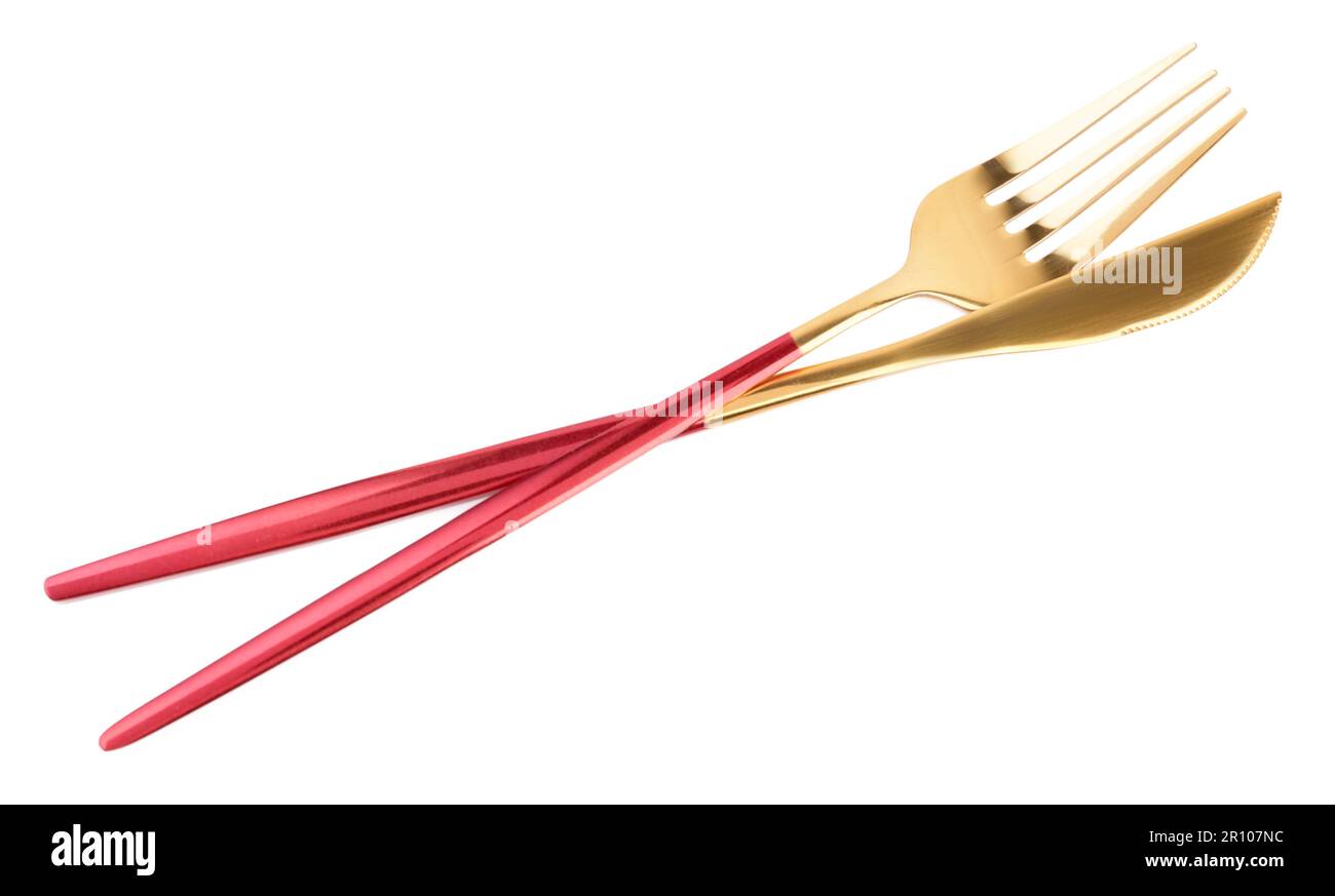 Golden fork and knife with red handles on white background Stock Photo ...