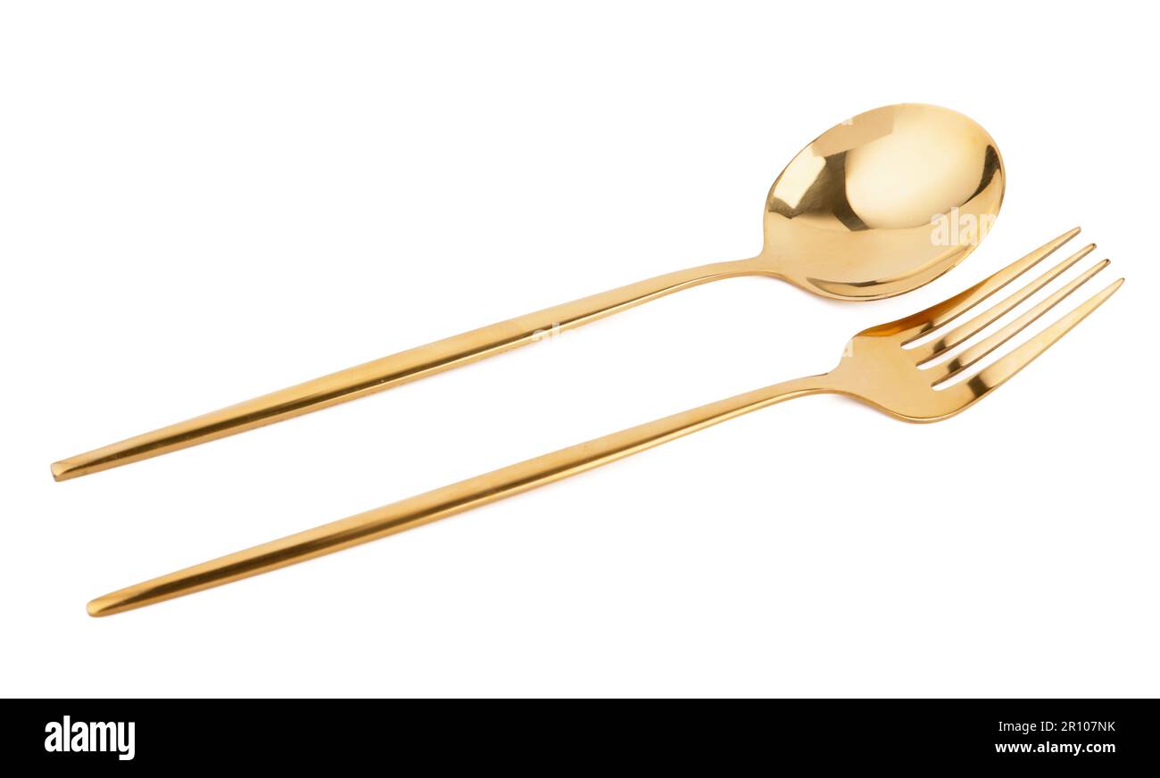 Golden spoon and fork on white background Stock Photo - Alamy