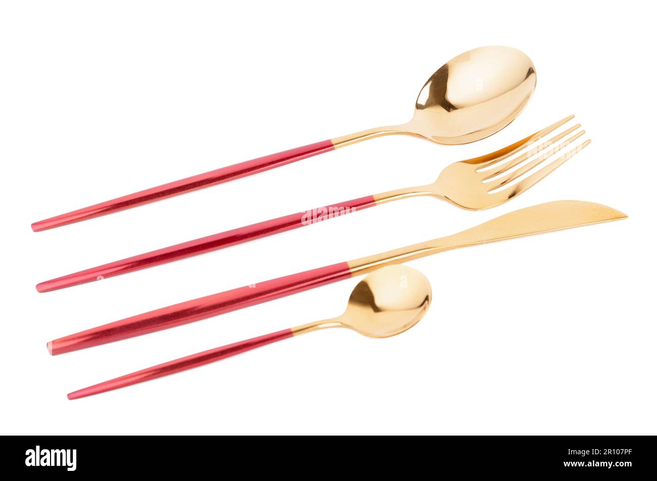 Golden set of cutlery with red handles on white background Stock Photo - Alamy