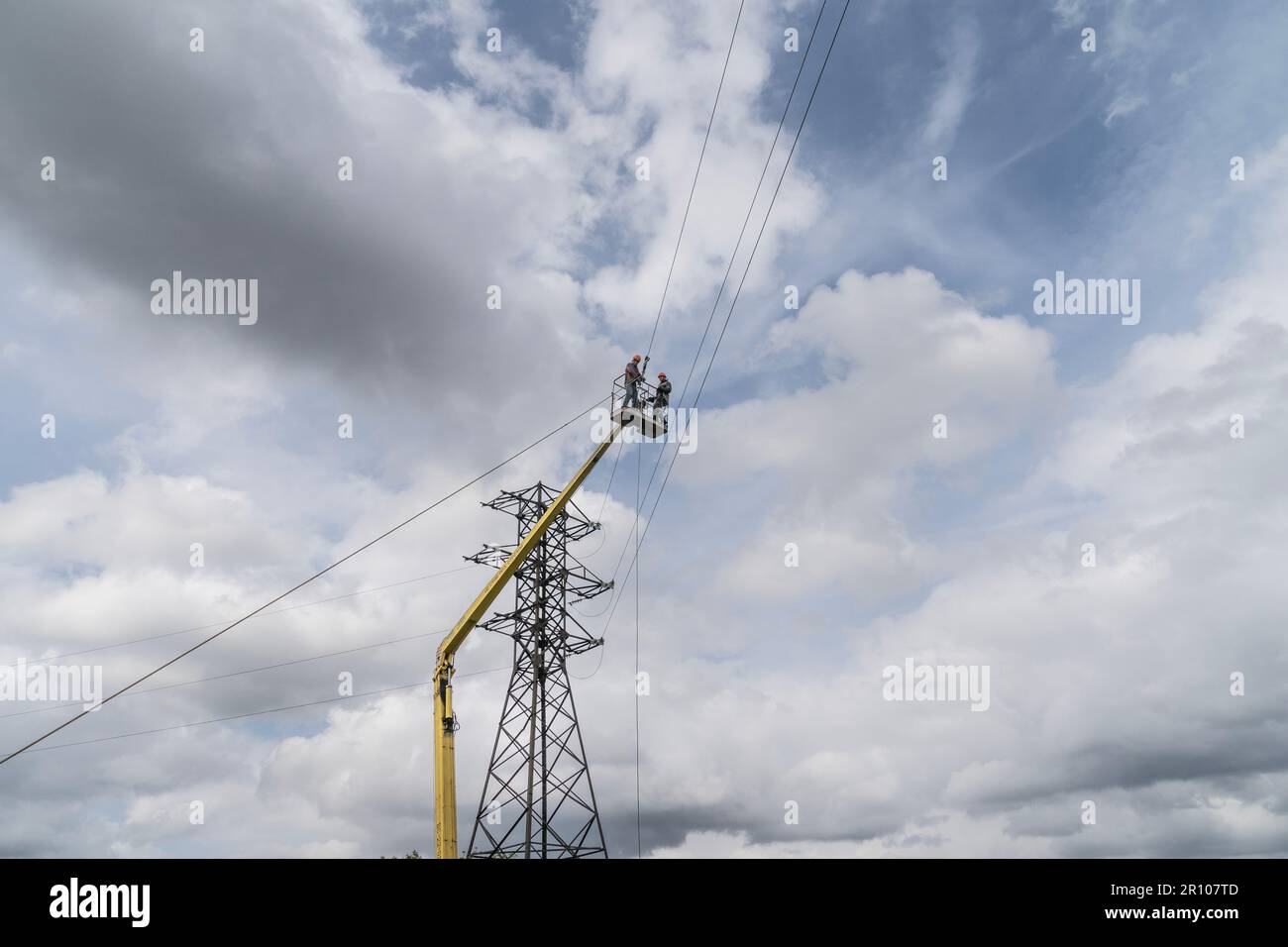Workers fixing electric power transmission line destroyed during ...