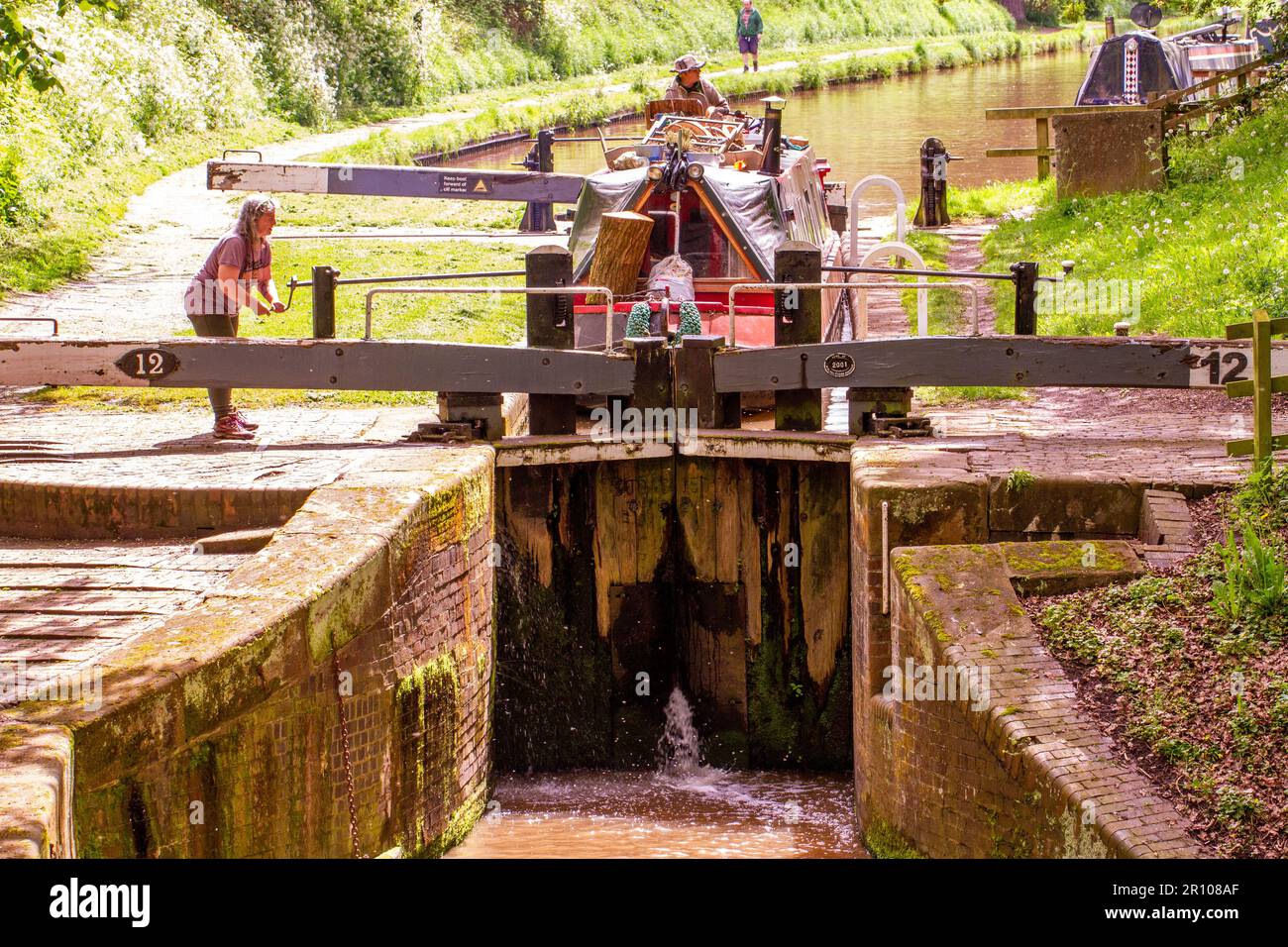 Canal narrowboat passing through a lock on the Shropshire Union canal ...